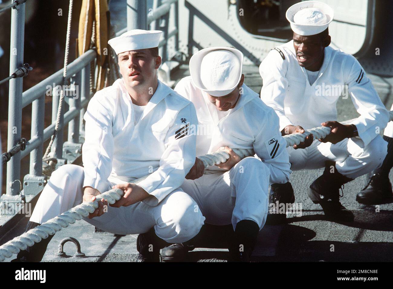 Line handlers aboard the guided missile cruiser USS JOSEPHUS DANIELS ...