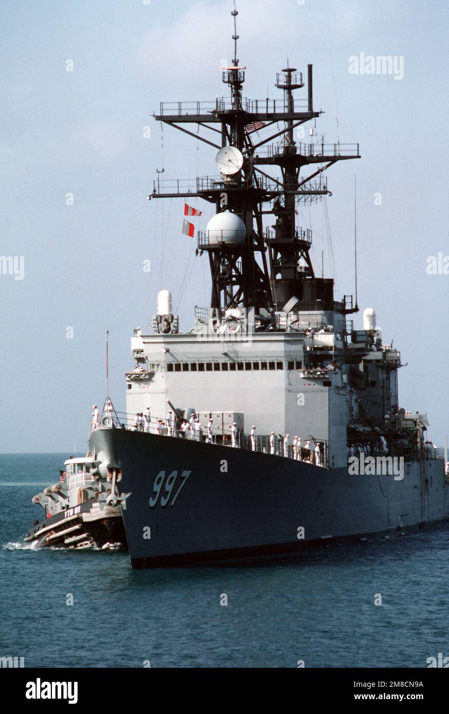 The large harbor tug HOUMA (YTB-811) maneuvers the guided missile ...