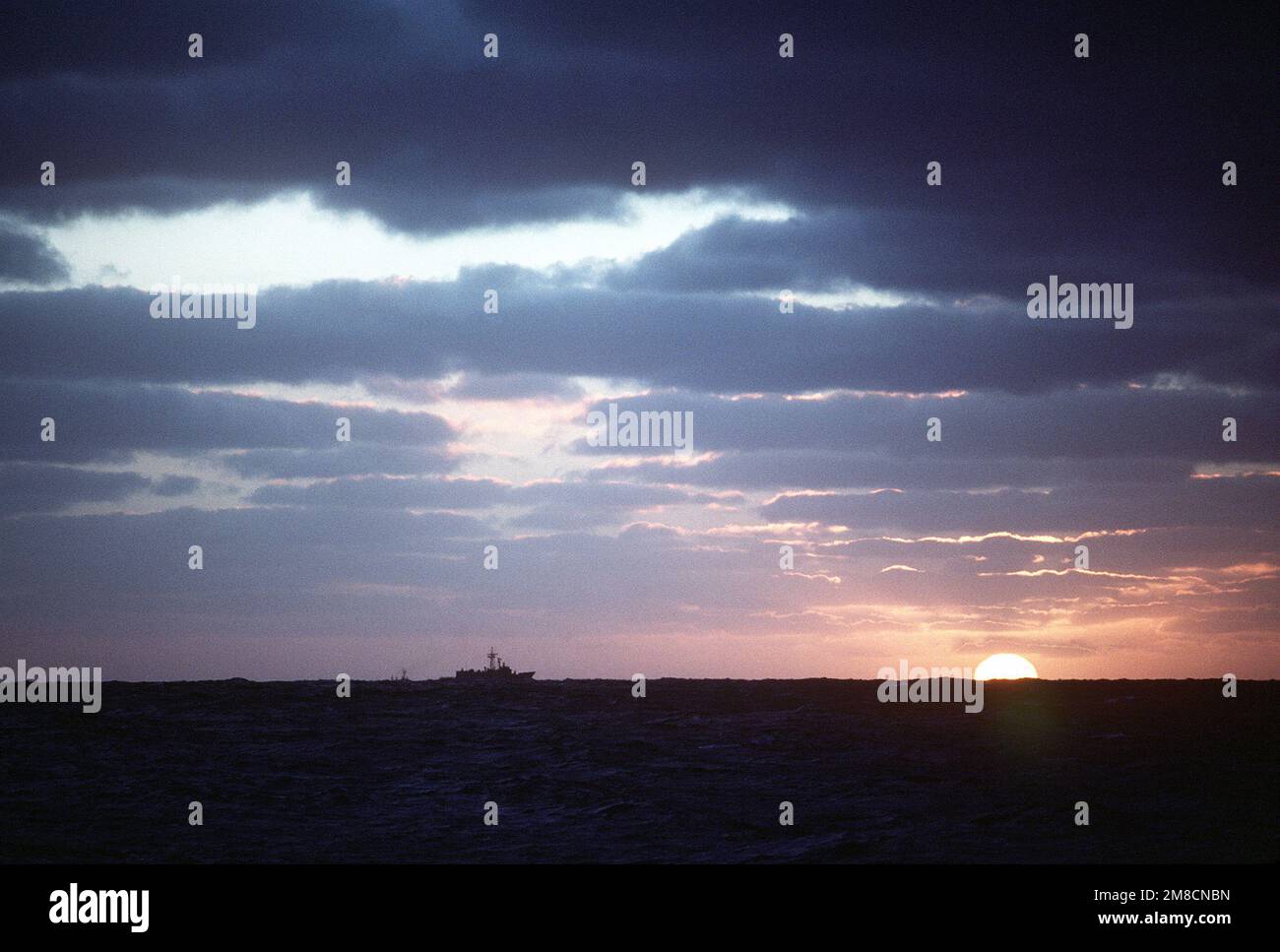 A ship is silhouetted on the horizon as it is underway during Unitas ...