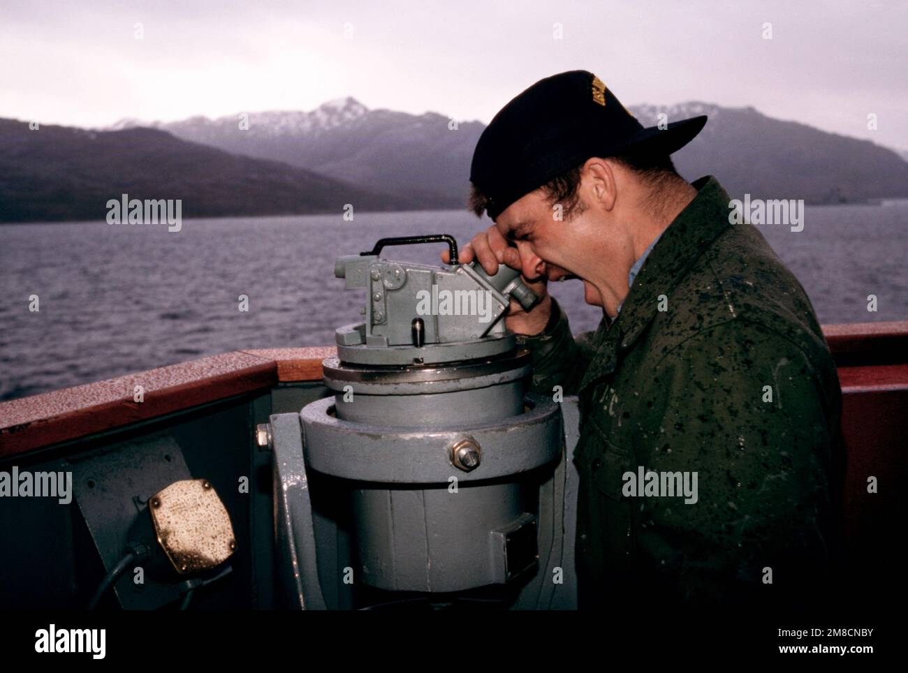 A crew member aboard the guided missile cruiser USS JOSEPHUS DANIELS ...