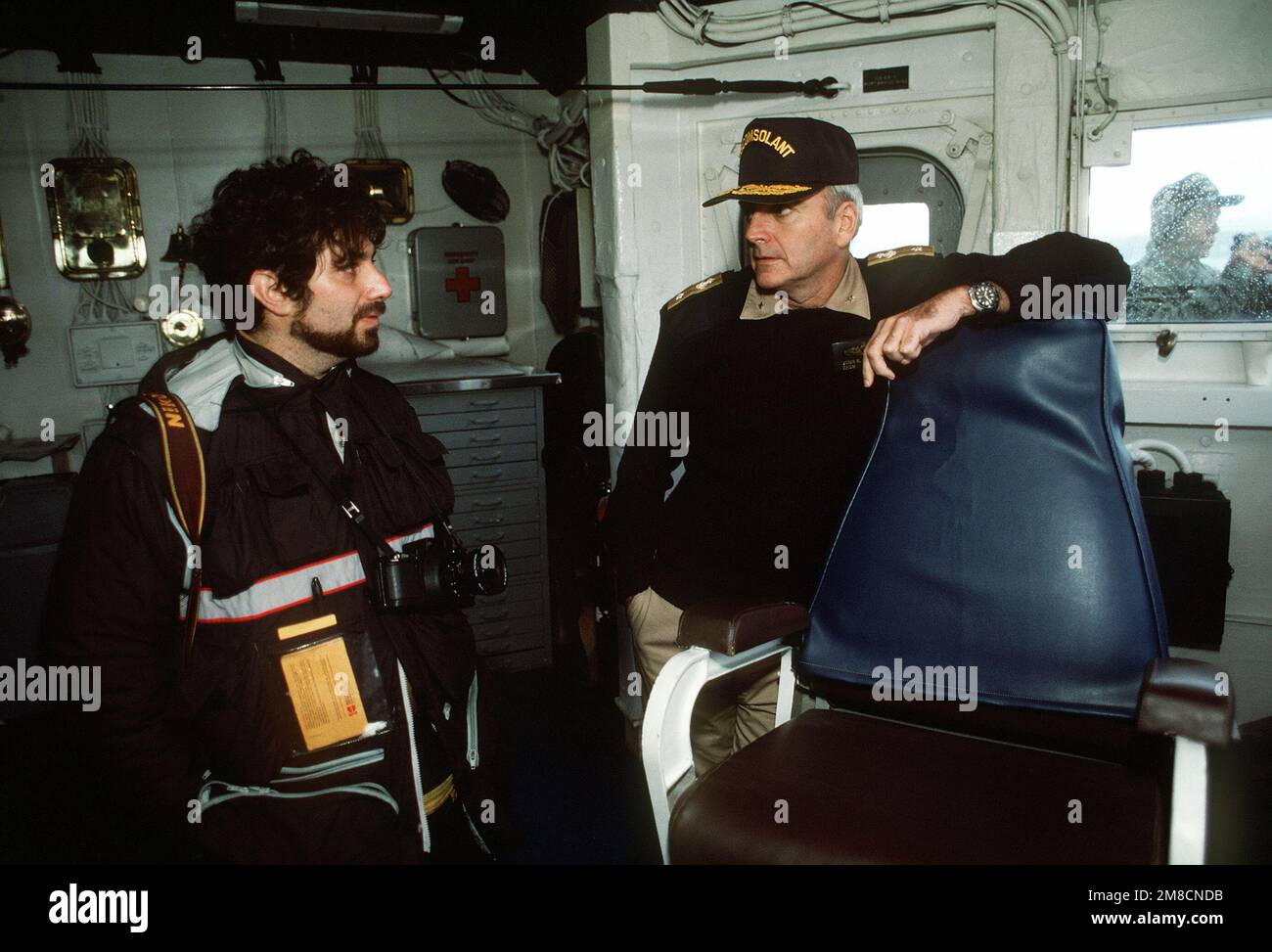 Commercial photographer Brian Wolfe speaks with RDML (lower half) John ...