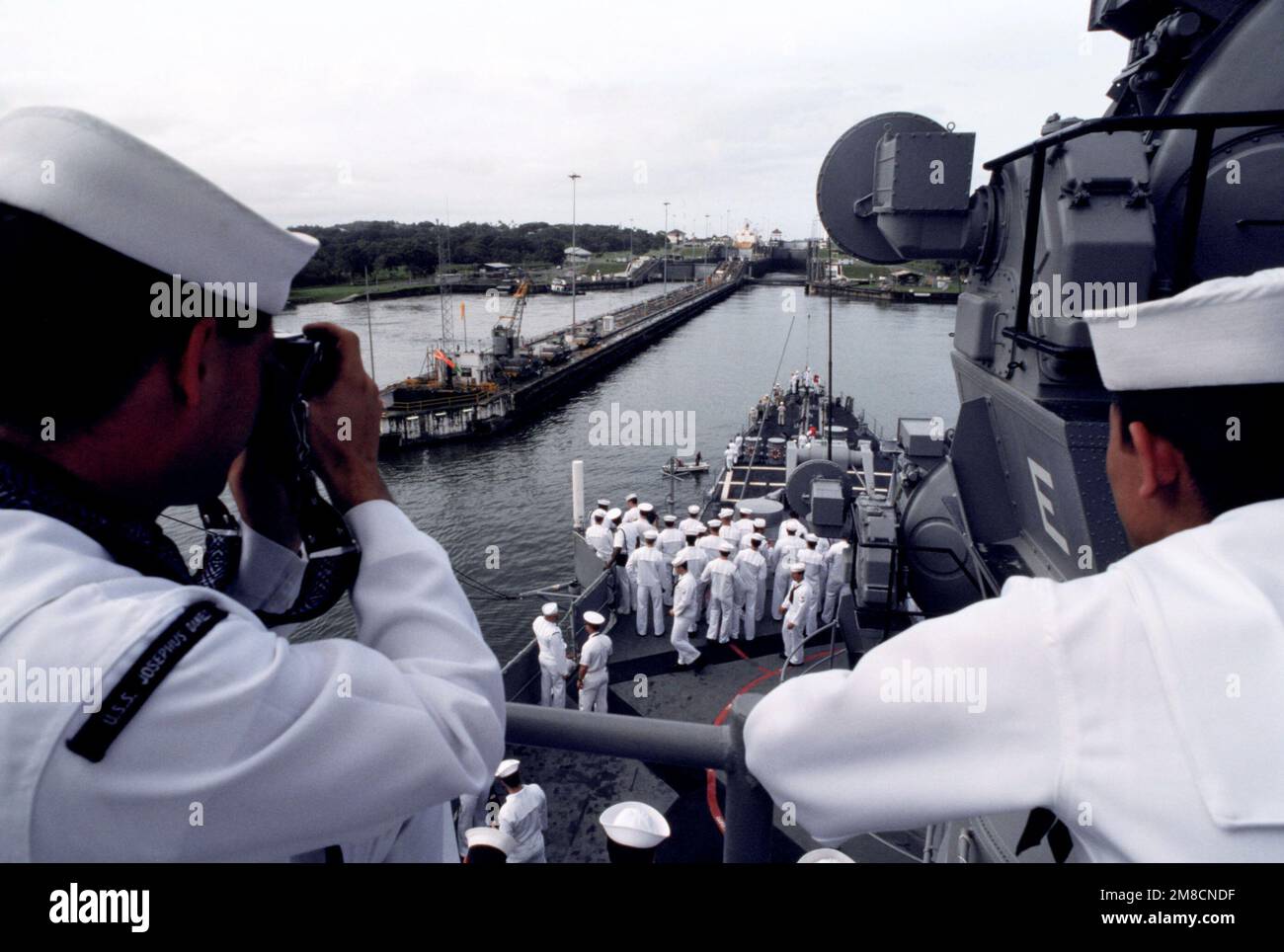 A crew member aboard the guided missile cruiser USS JOSEPHUS DANIELS ...