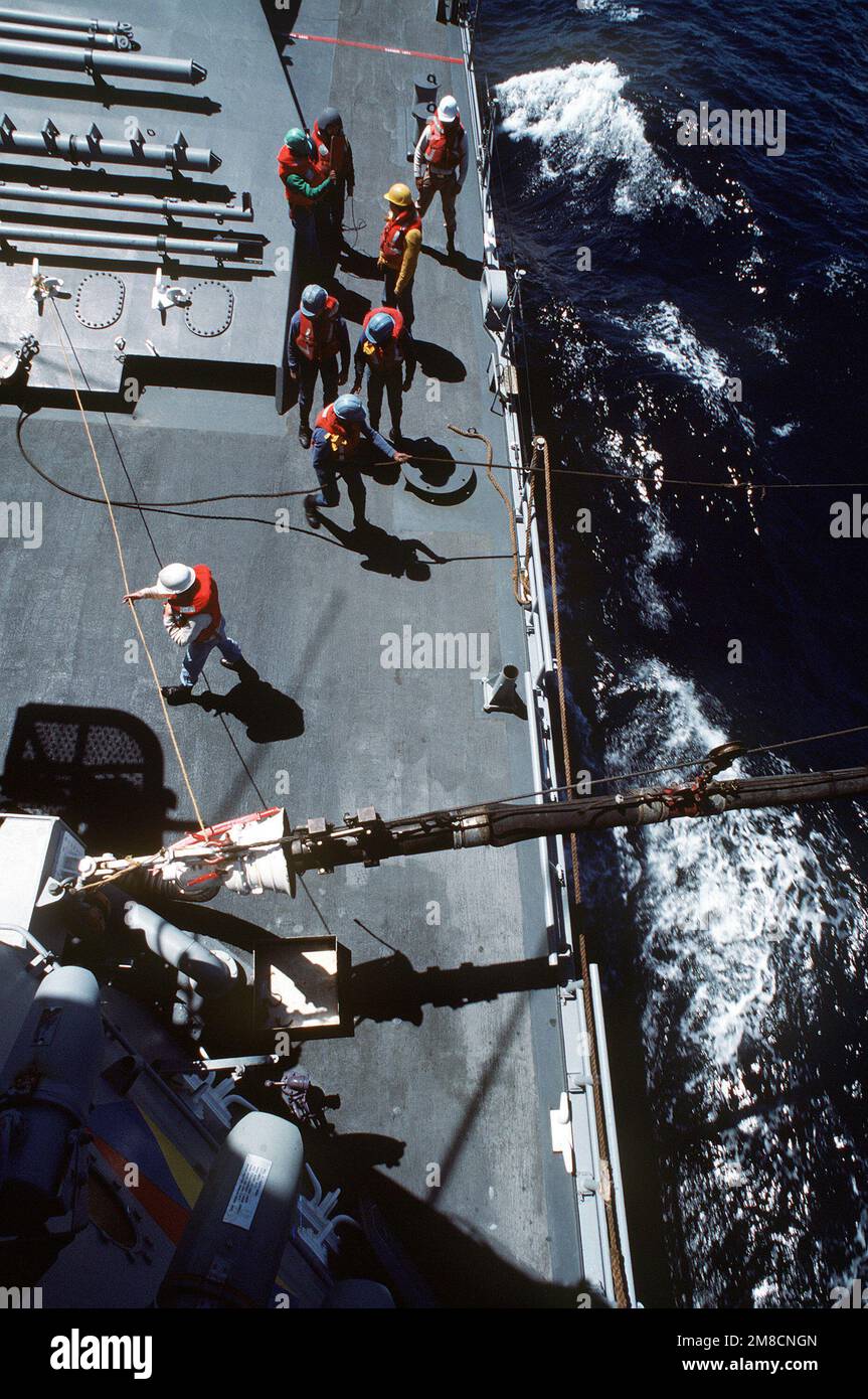 A crew member checks a rope securing the refueling probe to the ...