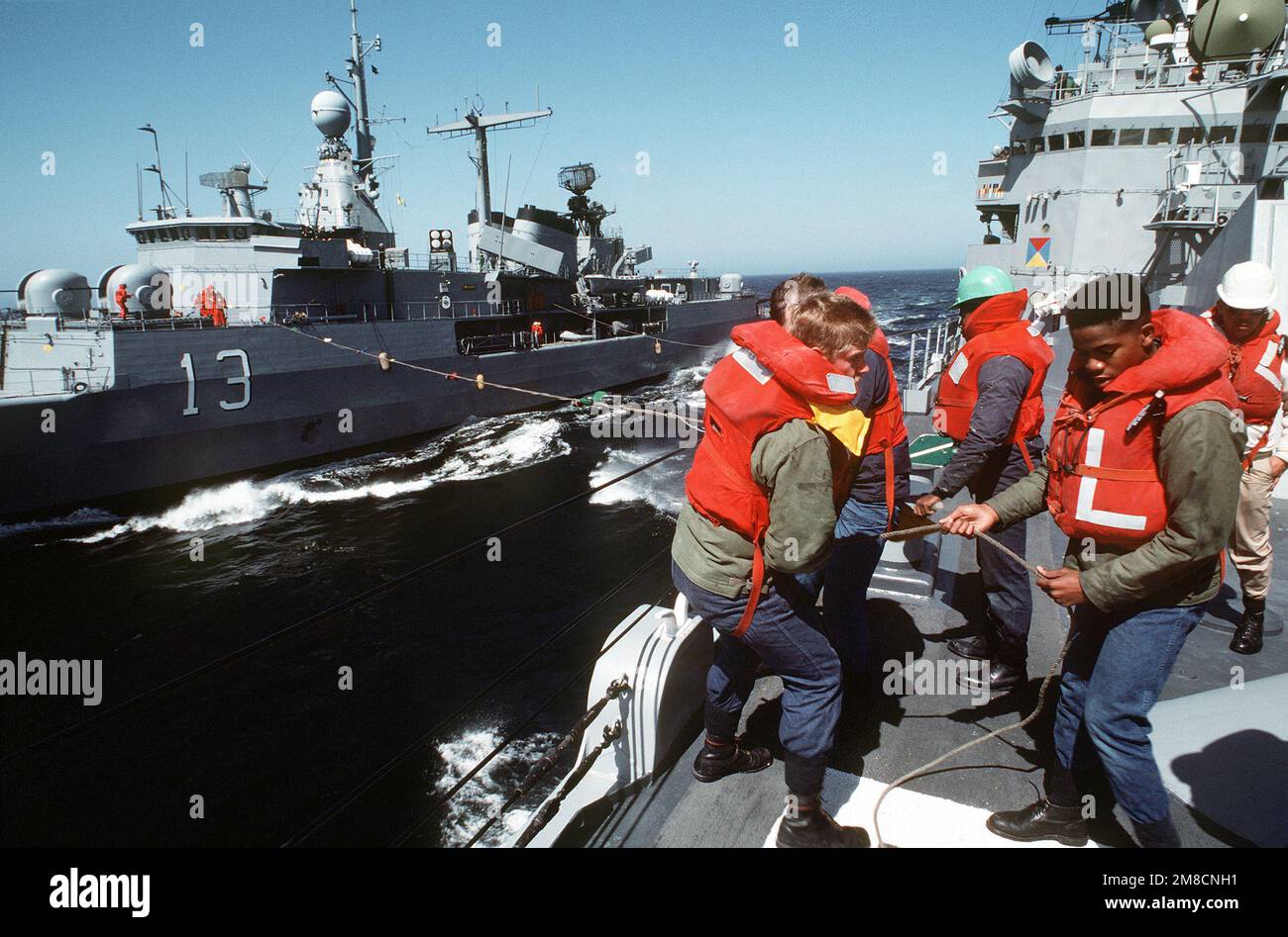 Crew members aboard the guided missile cruiser USS JOSEPHUS DANIELS (CG ...