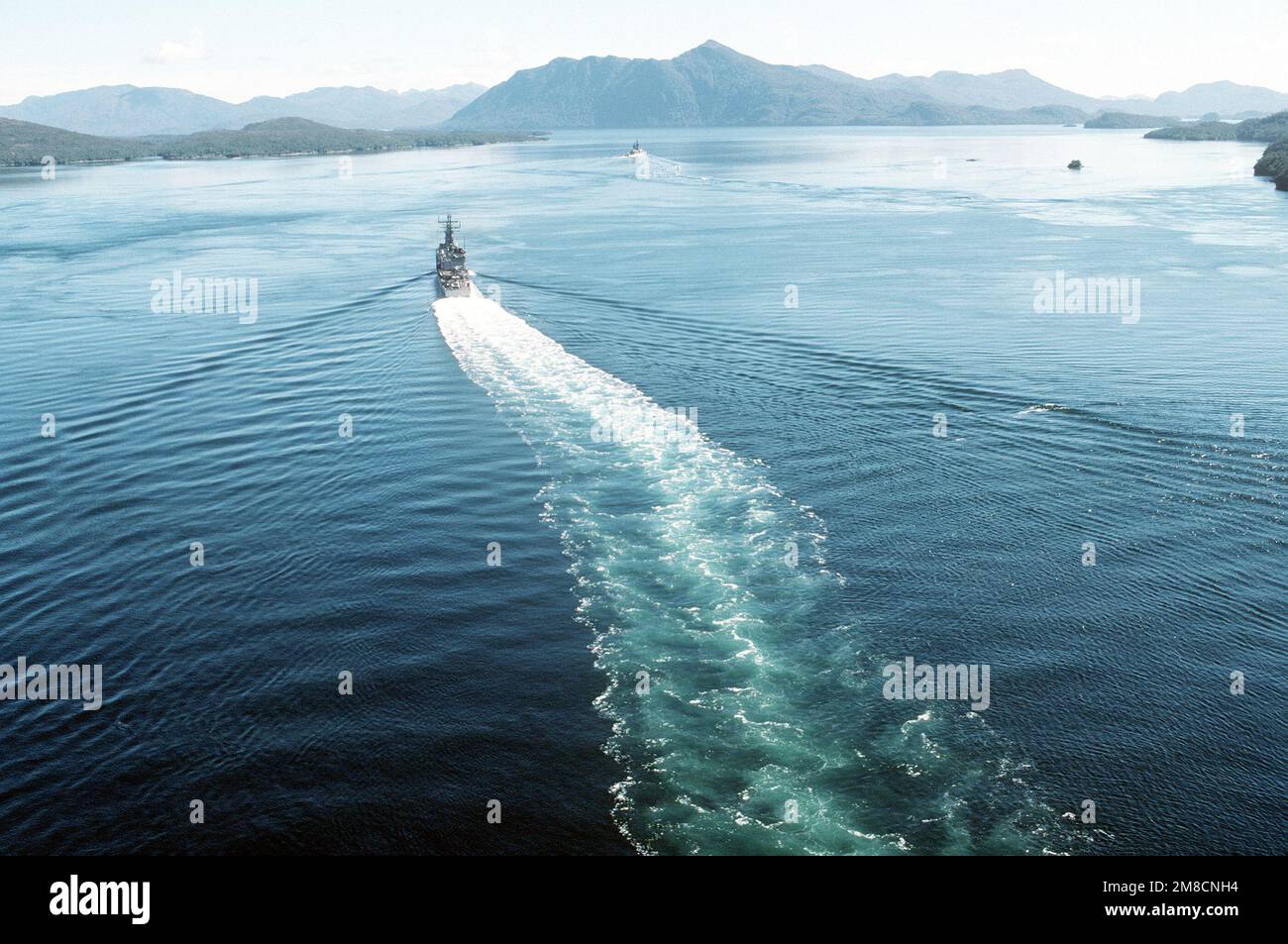 The destroyer USS HAYLER (DD-997) follows the guided missile cruiser ...