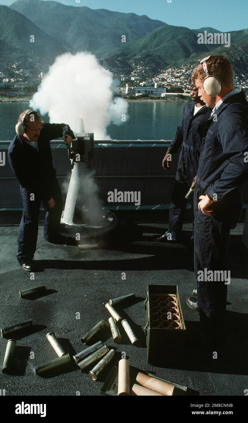 A crew member aboard the guided missile cruiser USS JOSEPHUS DANIELS ...