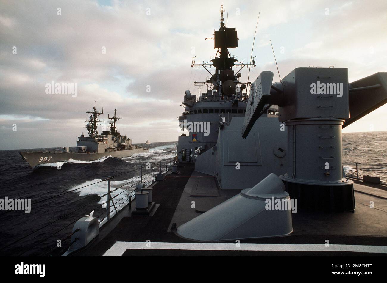 The destroyer USS HAYLER (DD-997) approaches the guided missile cruiser ...