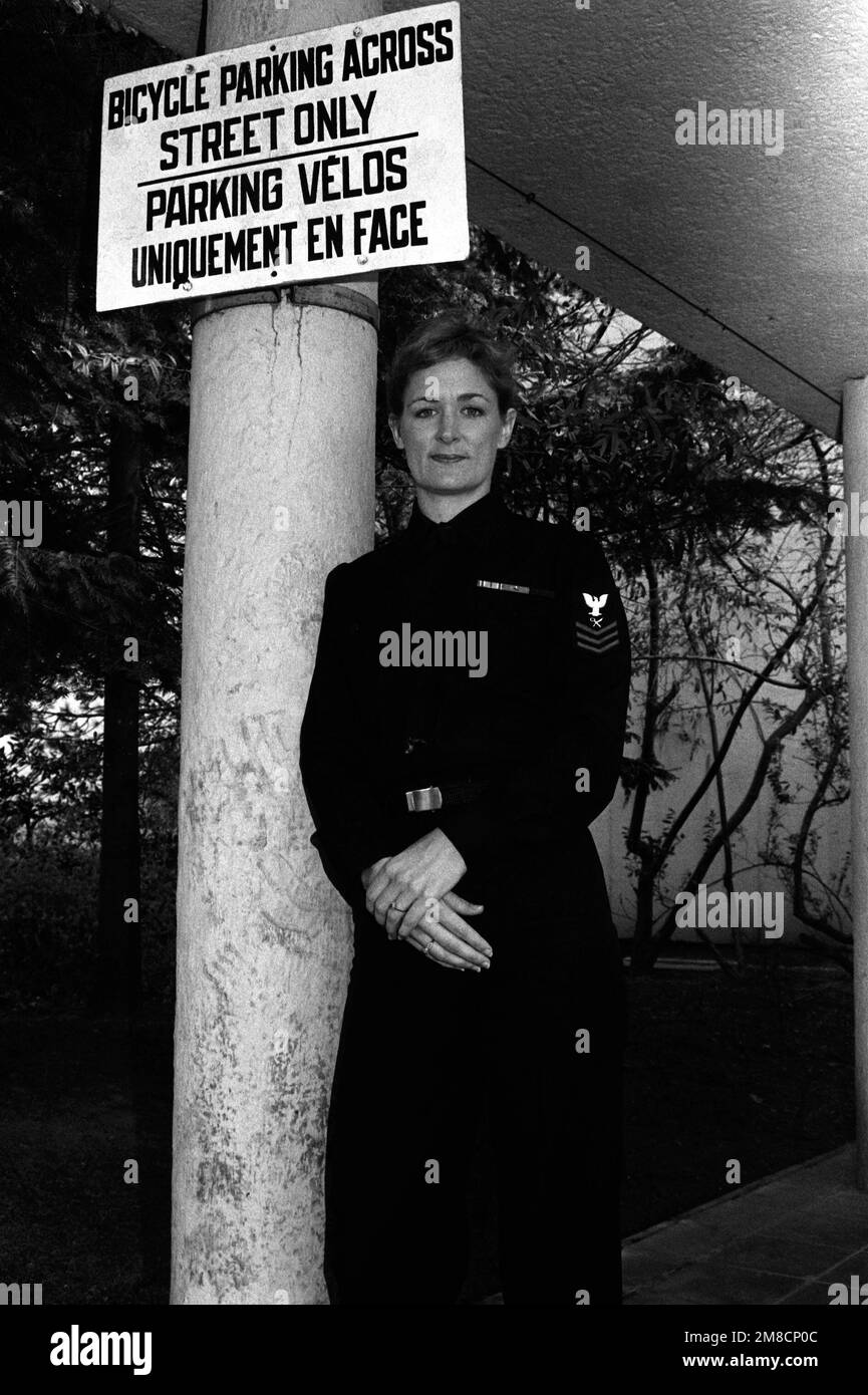 Yeoman 1ST Class Christie Leigh Bowers stands beside a sign printed in ...