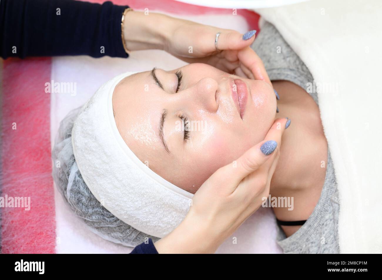 Applying cream and rubbing into skin, cosmetology relaxing procedure ...