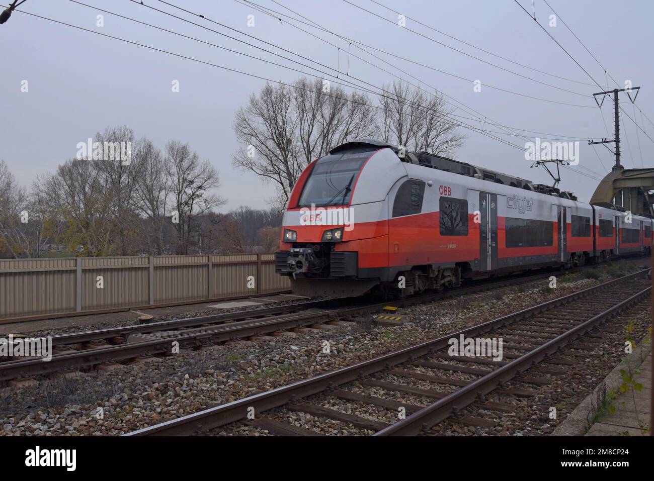 An OBB Austrian Railways Siemens Desiro Cityjet train crossing the Ostbahnsteg railway bridge ...