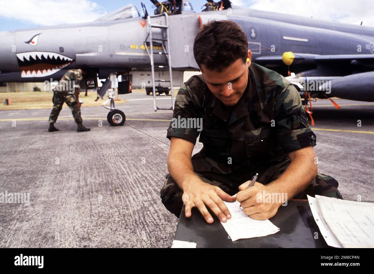 An airman from the 3rd Tactical Fighter Wing fills out a maintenance ...