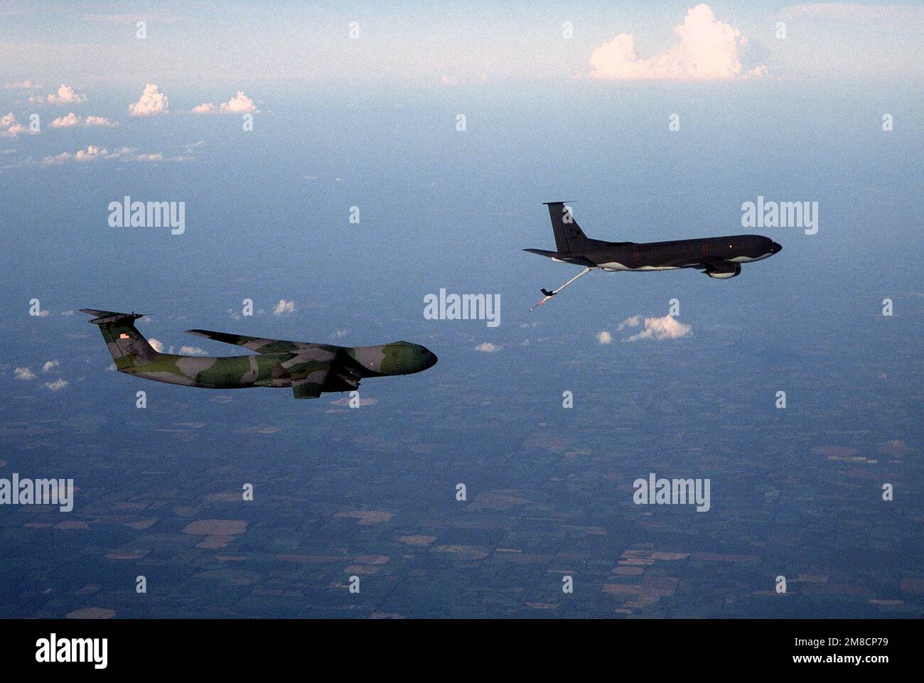 A 437th Military Airlift Wing C-141B Starlifter aircraft approaches a 19th Aerial Refueling Wing ...