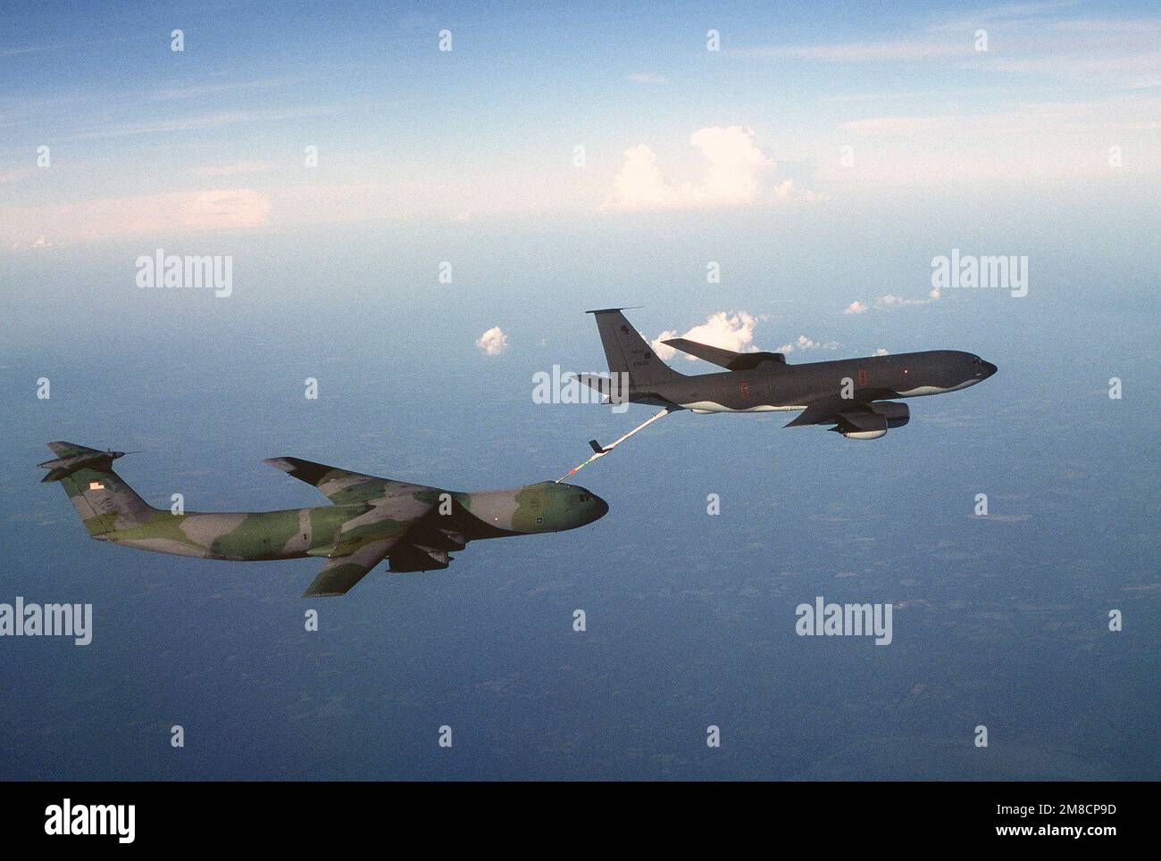 A 437th Military Airlift Wing C-141B Starlifter aircraft approaches a 19th Aerial Refueling Wing ...