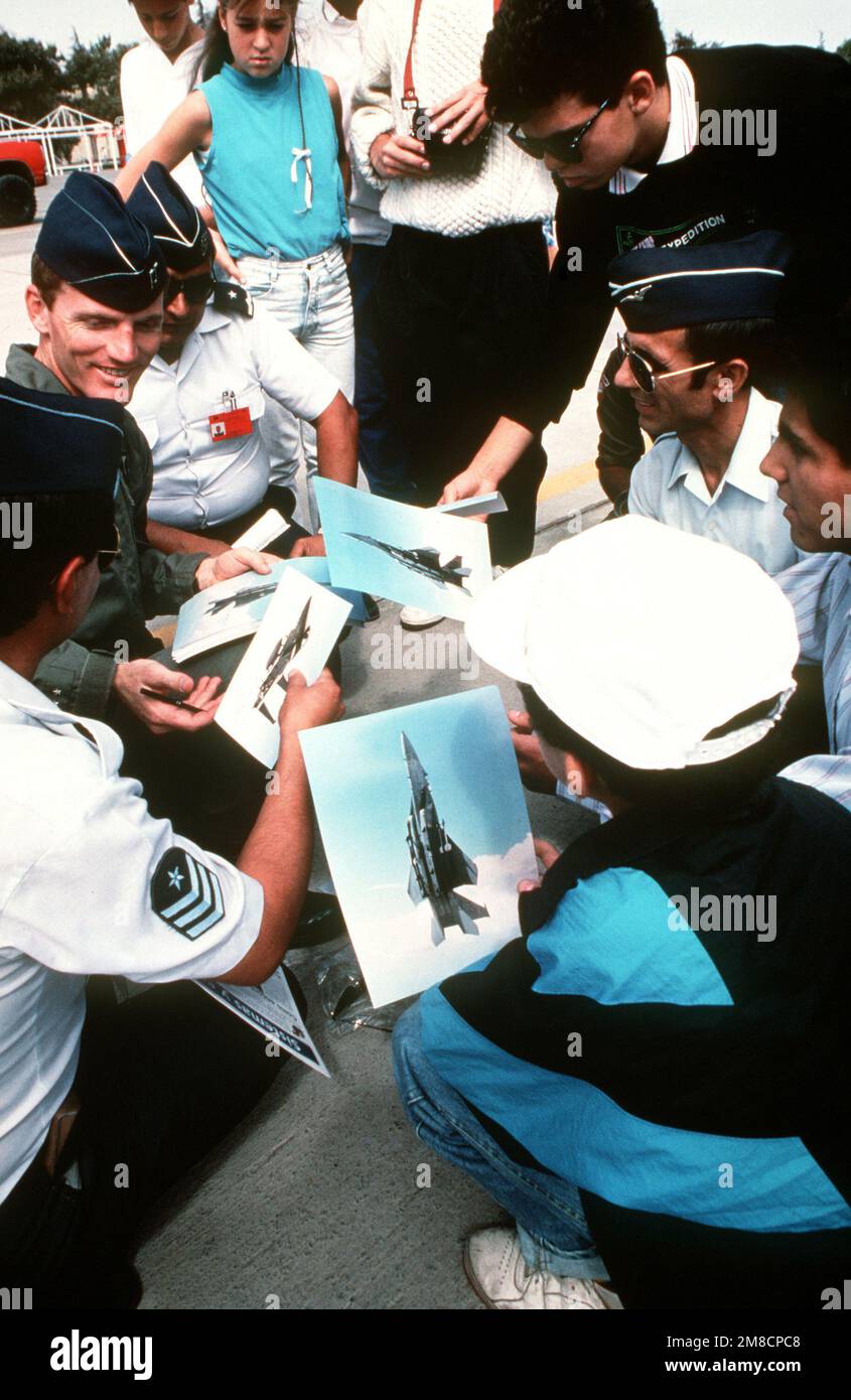 A 49th Tactical Fighter Wing pilot autographs pictures at the ...