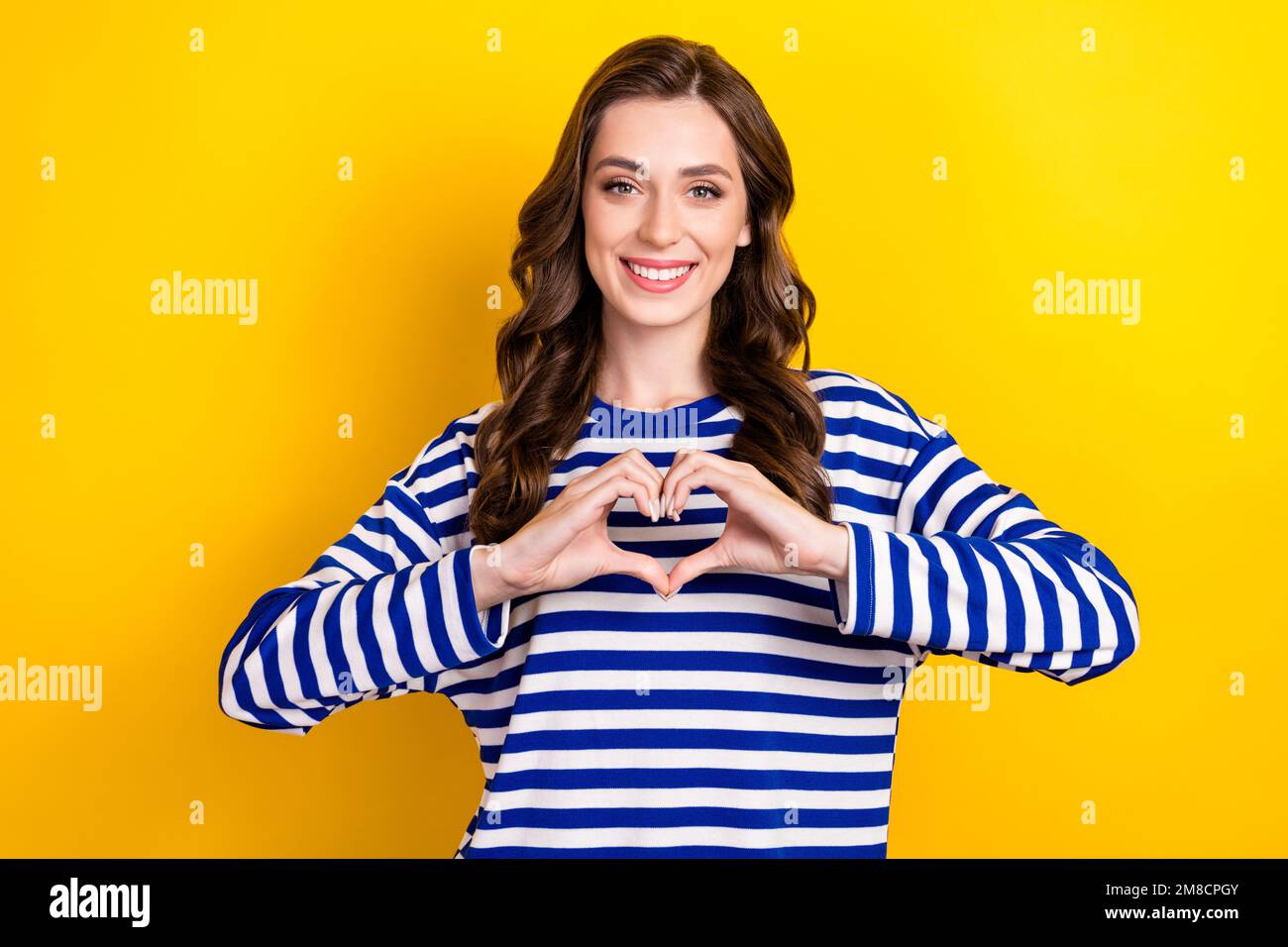 Photo portrait of lovely young lady arms show heart symbol toothy smile ...