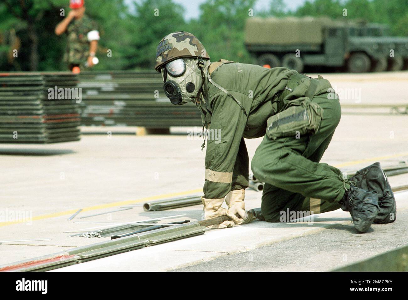 A member of the 833rd Civil Engineering Squadron connects fittings for ...