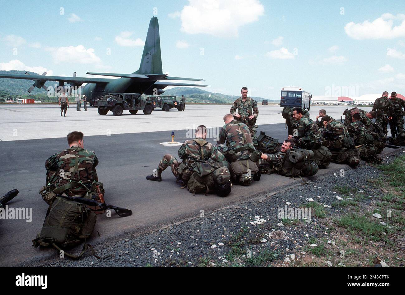Members of 1ST Battalion, 509th Infantry, wait for air transport to ...