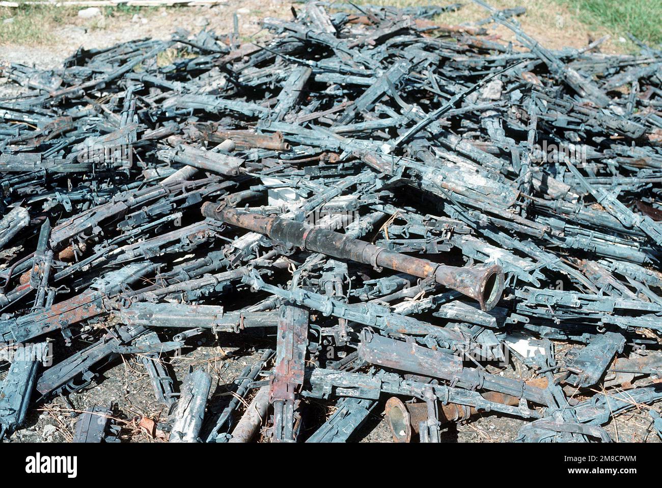 Scorched rifles, machines guns and rocket launchers lie in a heap after ...