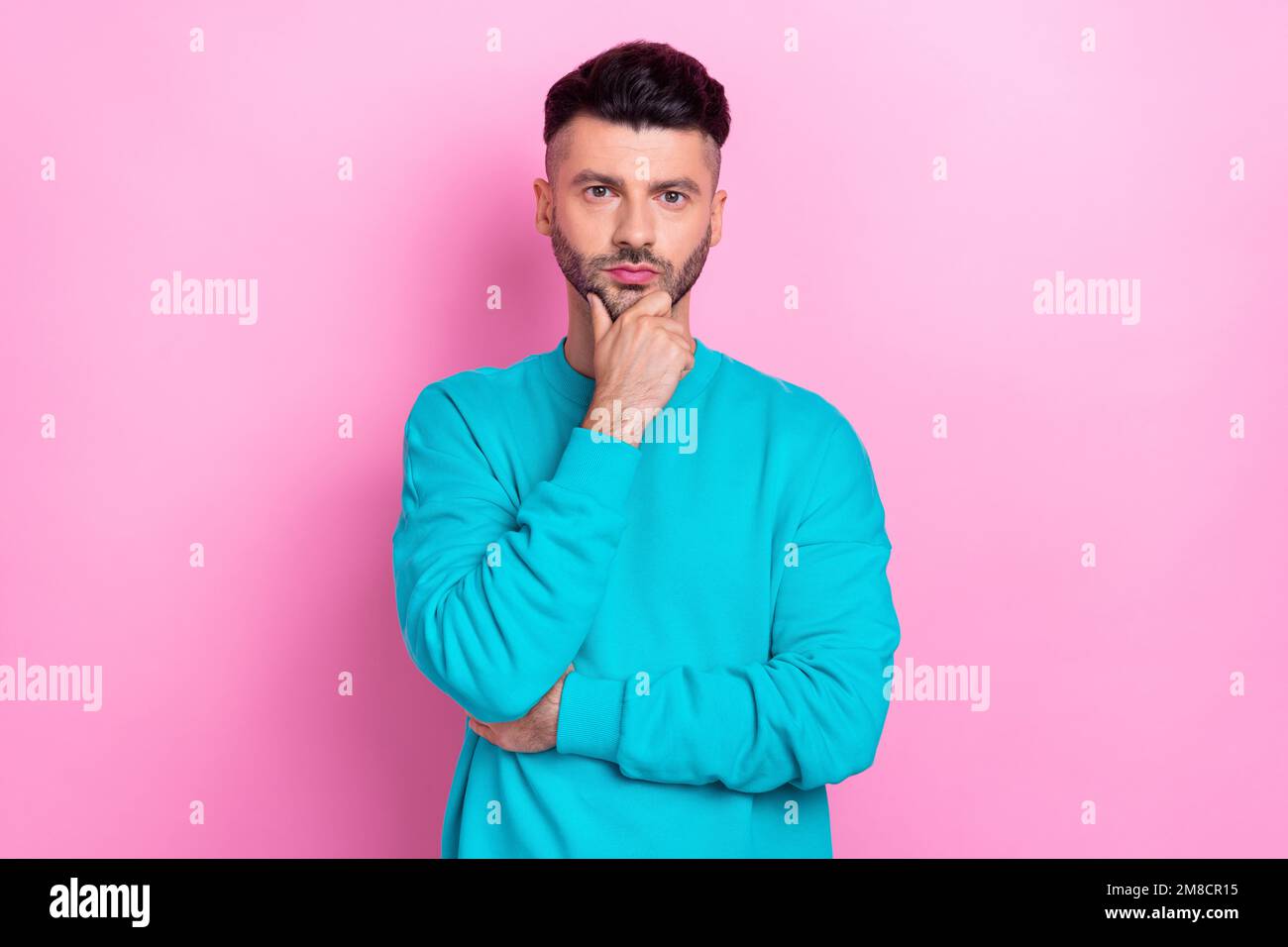 Portrait photo of young serious clever man influencer touch chin hands ...