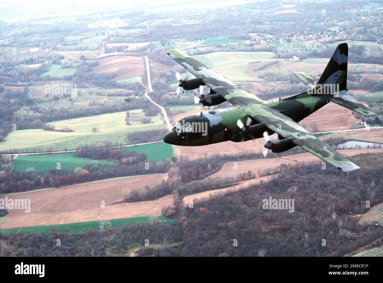 An air-to-air left side view of a C-130H Hercules aircraft of the 139th ...