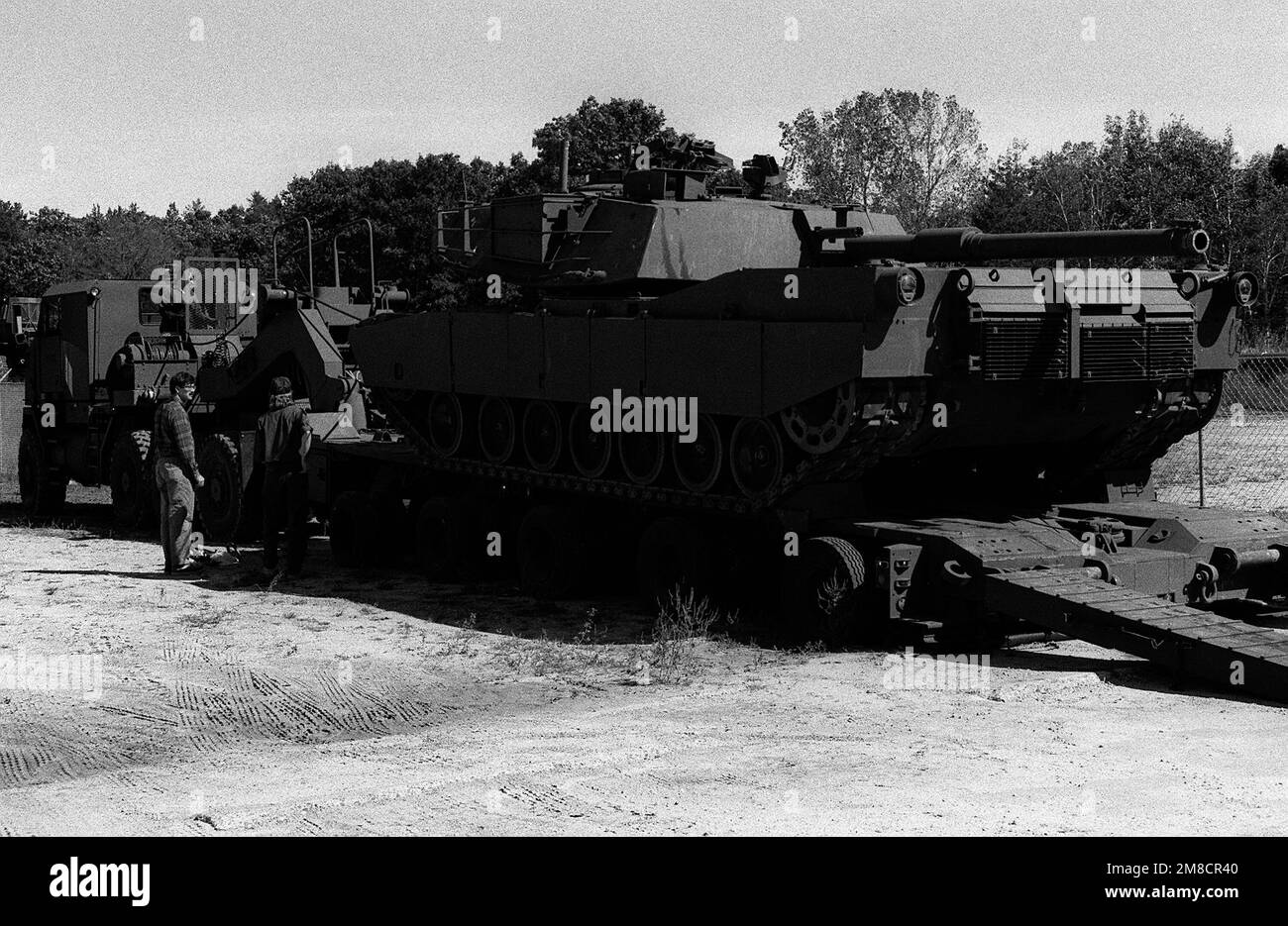 An M-1 Abrams main battle tank is secured to the bed of an M-1000 Heavy ...