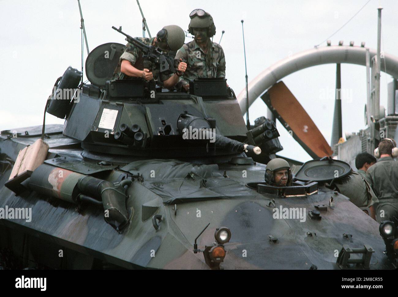 A vehicle commander places a 7.62mm M-240E1 machine gun in the pintle ...