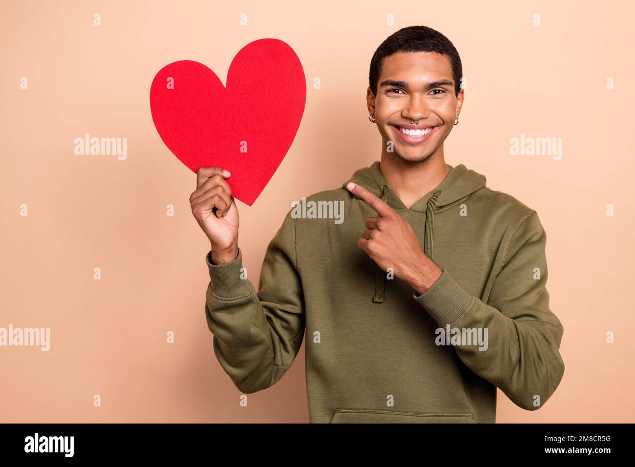 Photo of young satisfied smile man student hold red paper card indicate ...