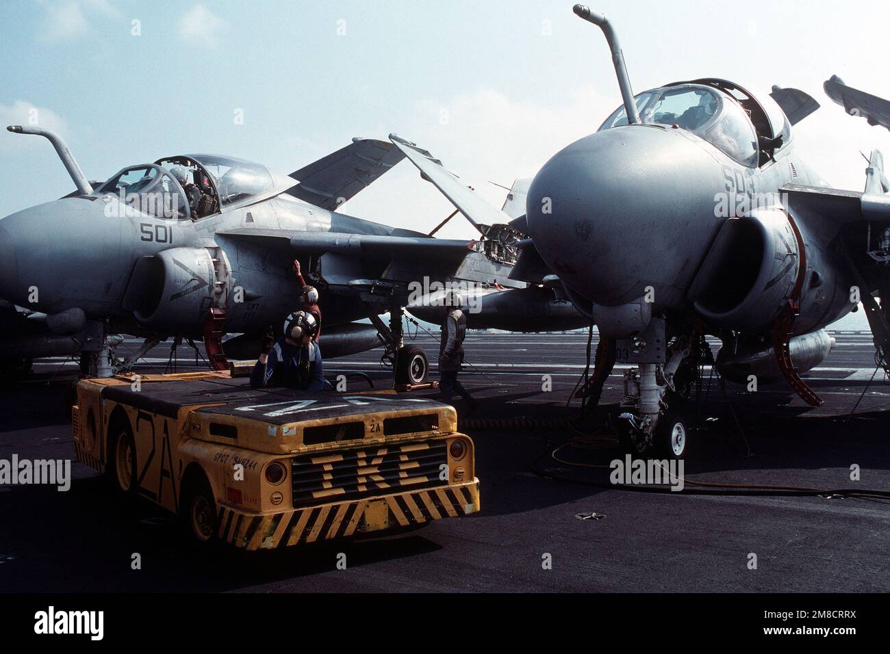 The operator of an MD-3A tow tractor provides compressed air to start ...