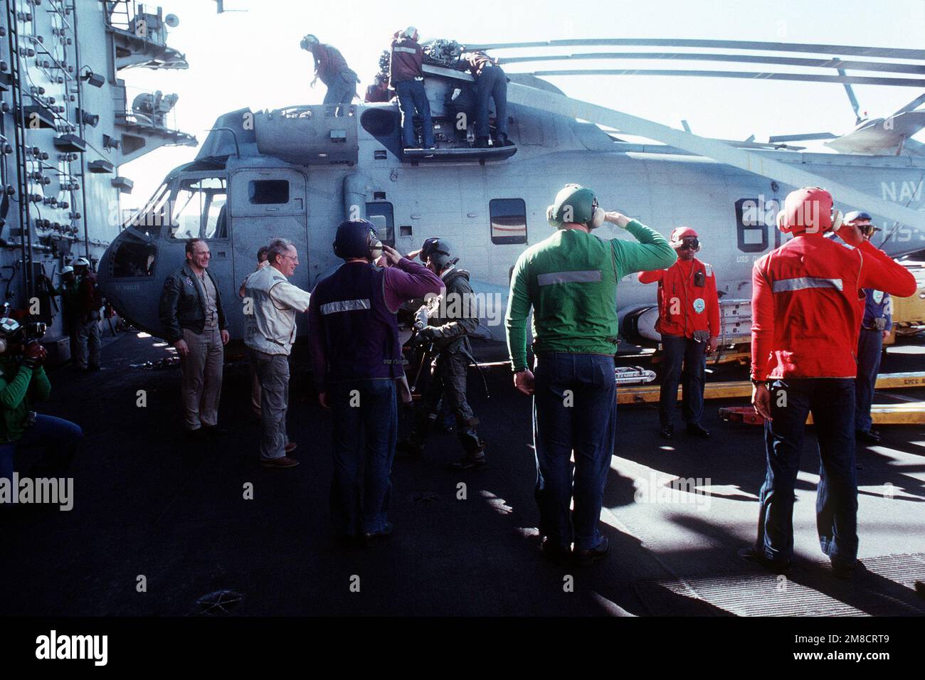 Sideboys salute as Secretary of the Navy H. Lawrence Garrett III, in ...