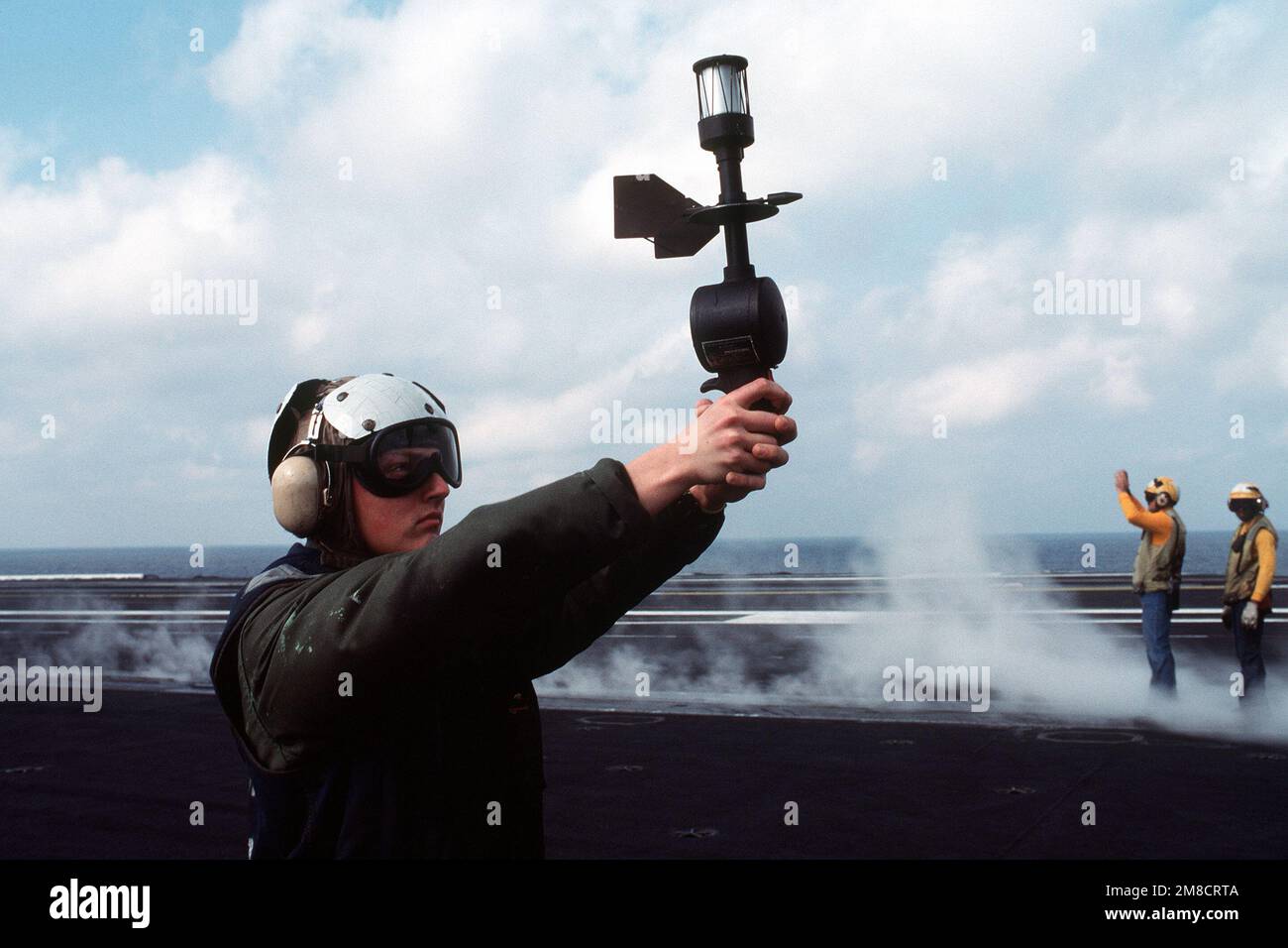 An aerographer's mate uses an AN/PMQ-3 anemometer to measure wind speed ...