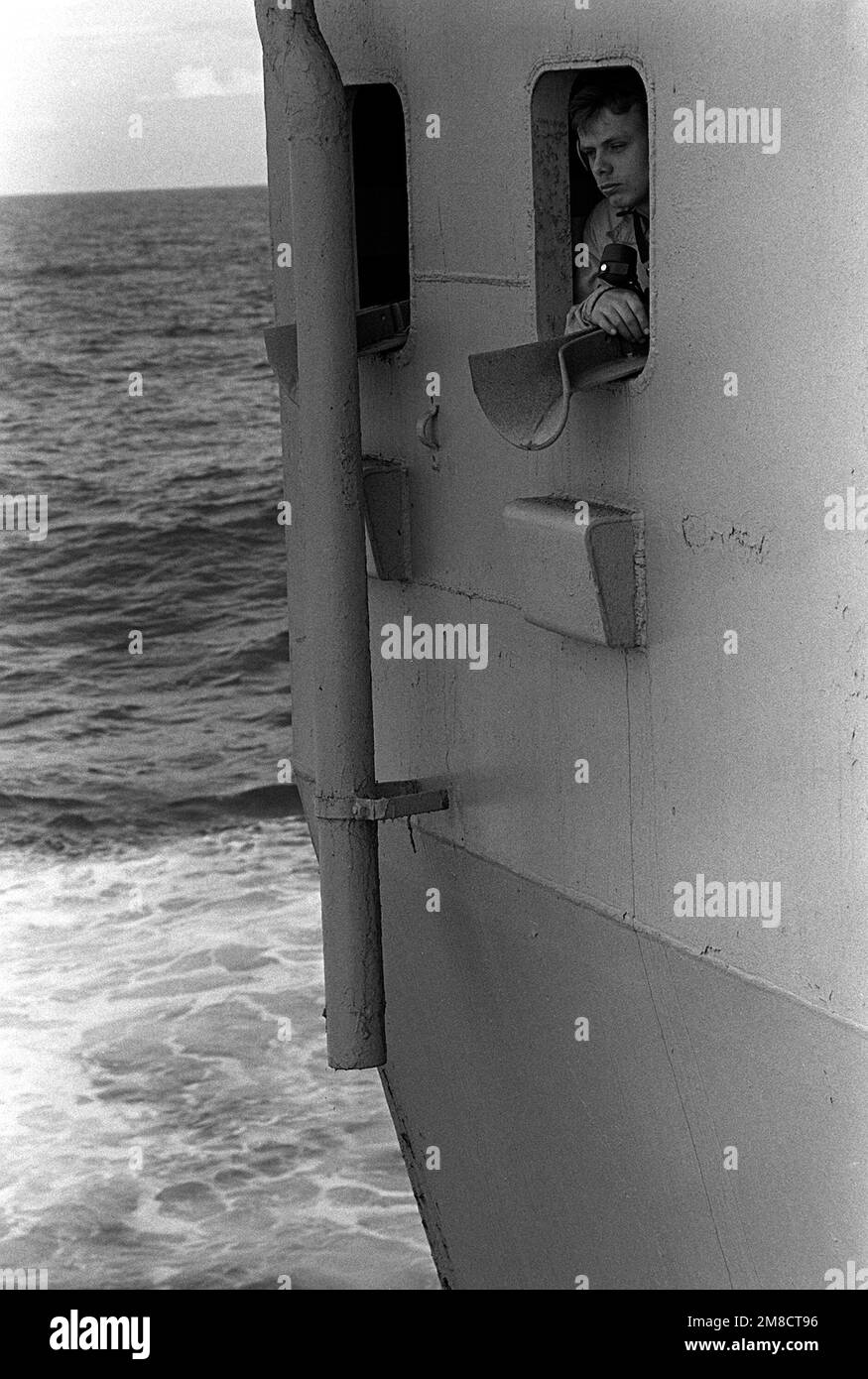 A sailor stands watch on the fantail of the nuclear-powered aircraft ...