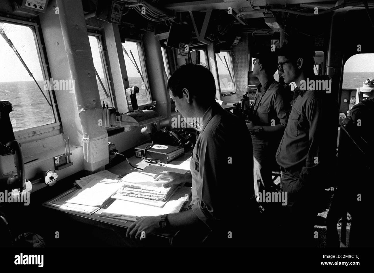 Navy personnel work at the pilot house aboard the destroyer USS ...