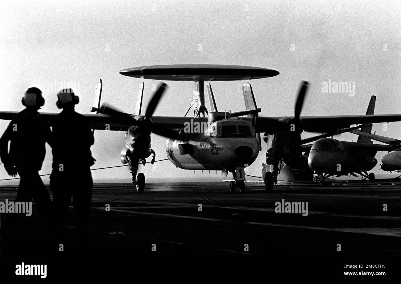 An E-2C Hawkeye aircraft catches the arresting cables as it lands on ...