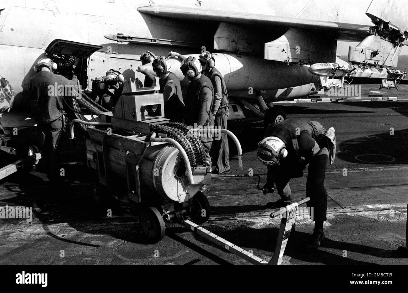 Ordnance crew members use a Linkless Ammunition Loading System (LALS ...