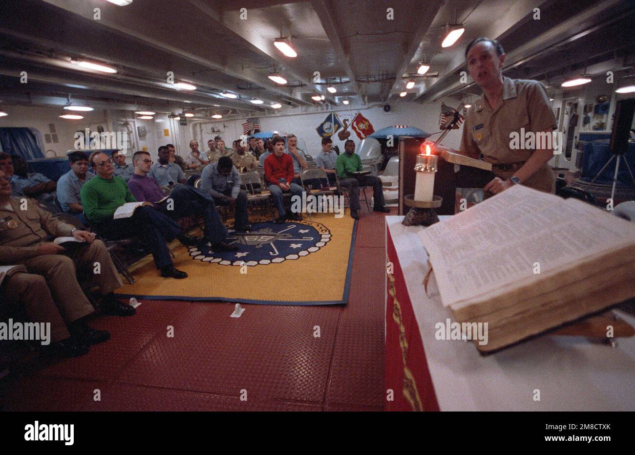 Crew members attend a Protestant worship service conducted by Chaplain ...