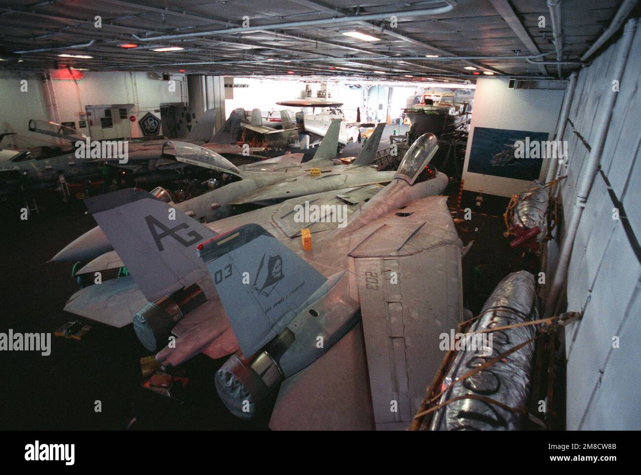 Aircraft crowd the hangar deck aboard the nuclear-powered aircraft ...