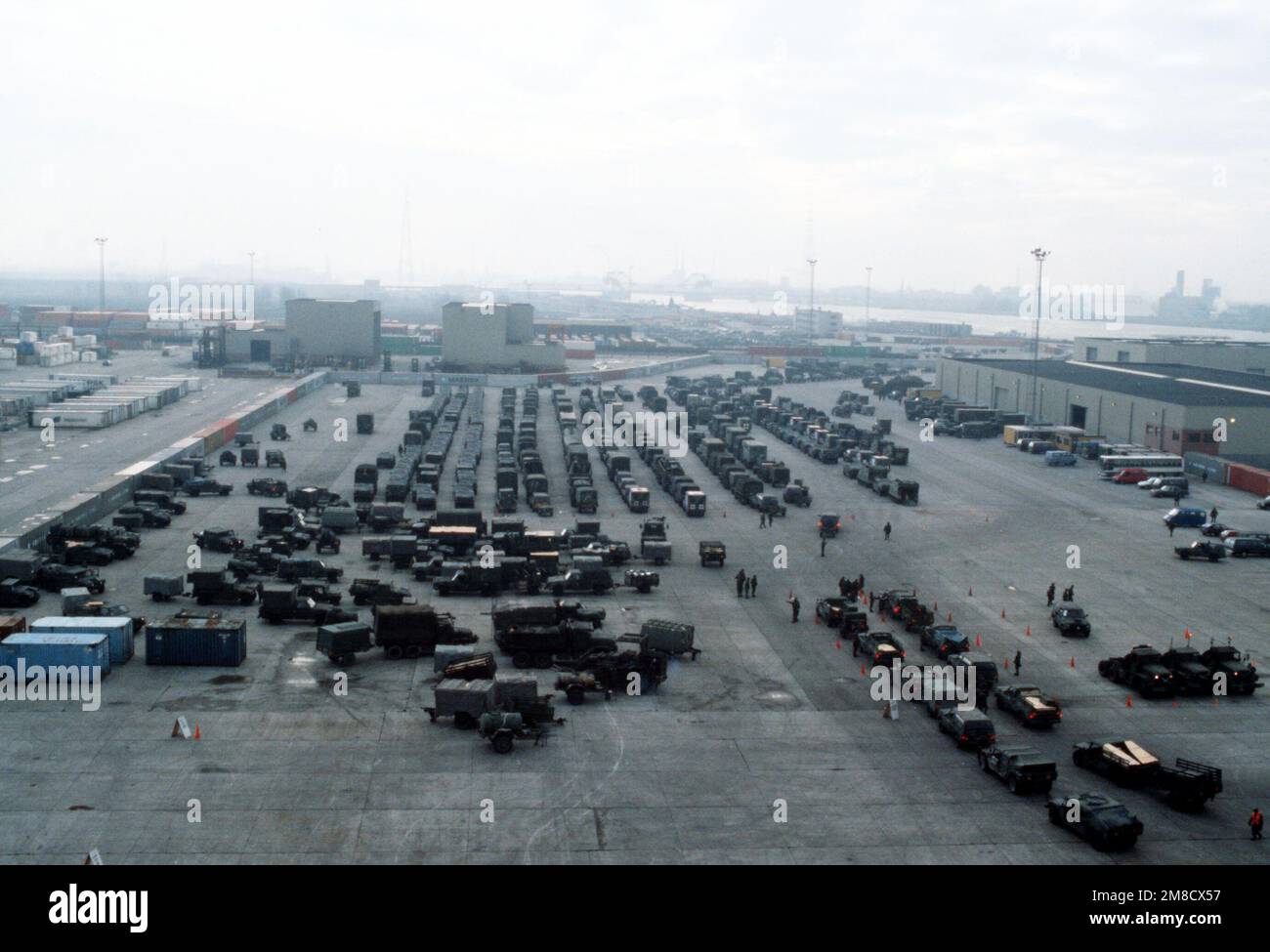 Military vehicles and equipment line the port area during exercise ...