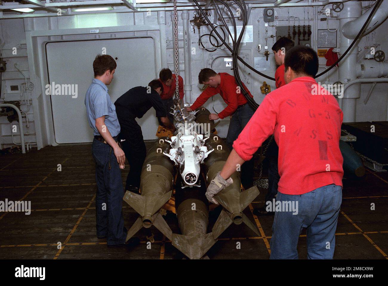 Weapons technicians aboard the nuclear-powered aircraft carrier USS ...