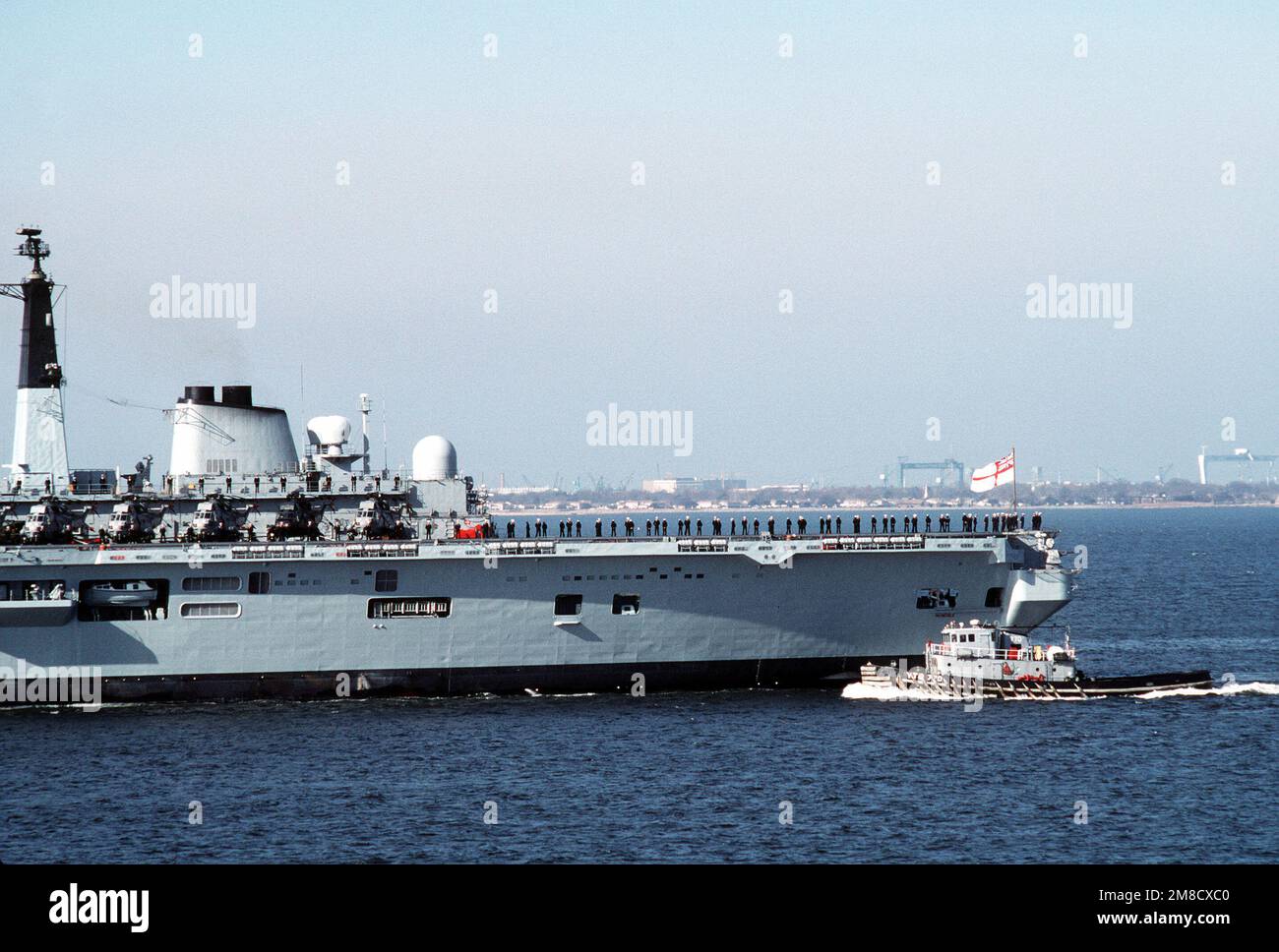 The large harbor tug DAHLONEGA (YTB-770) pulls alongside the stern ...