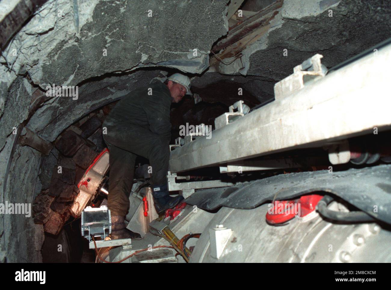 A West German engineer inspects a tunnel boring machine inside a South ...