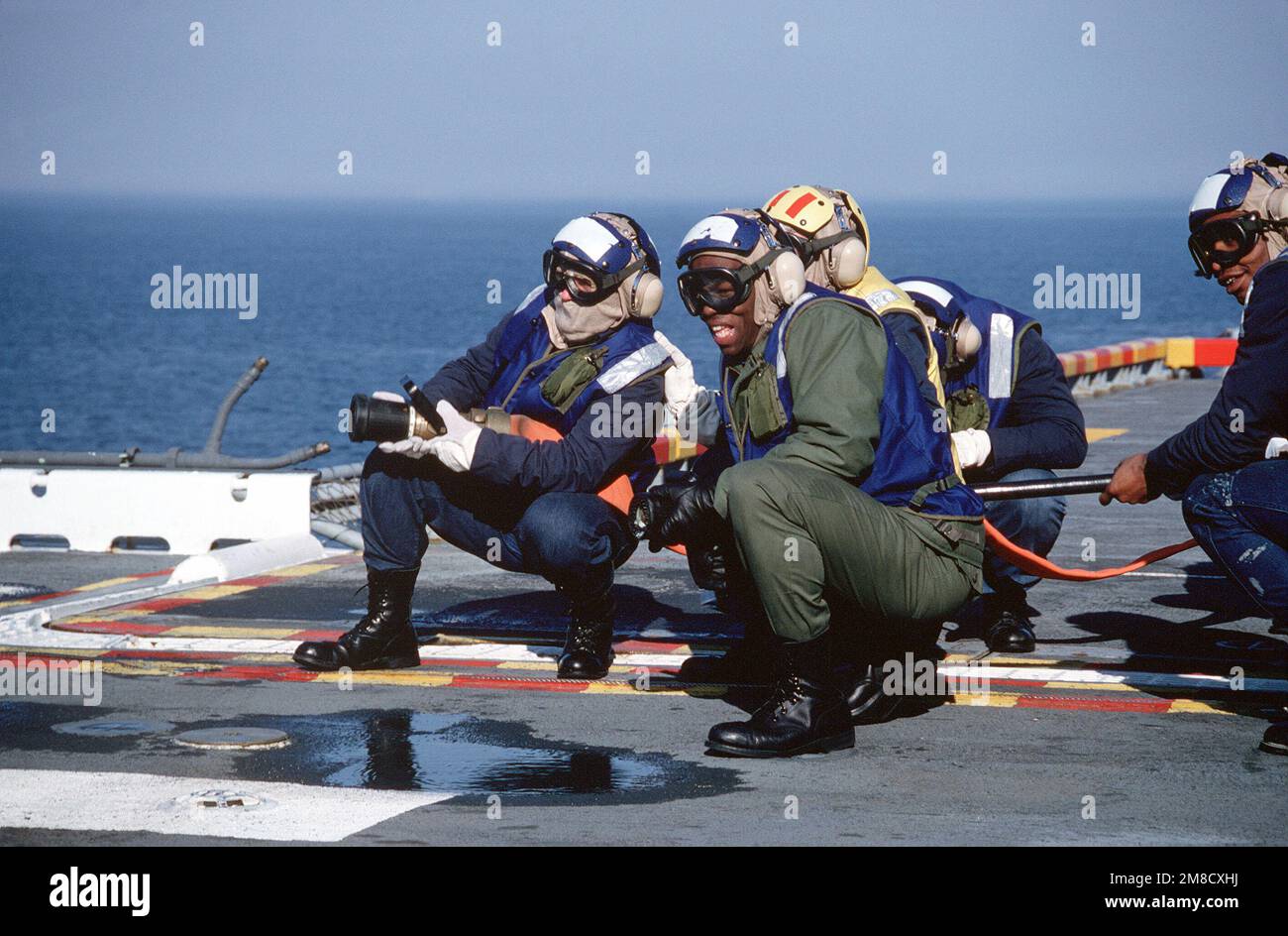 Members of the flight deck fire party aboard the amphibious assault ...