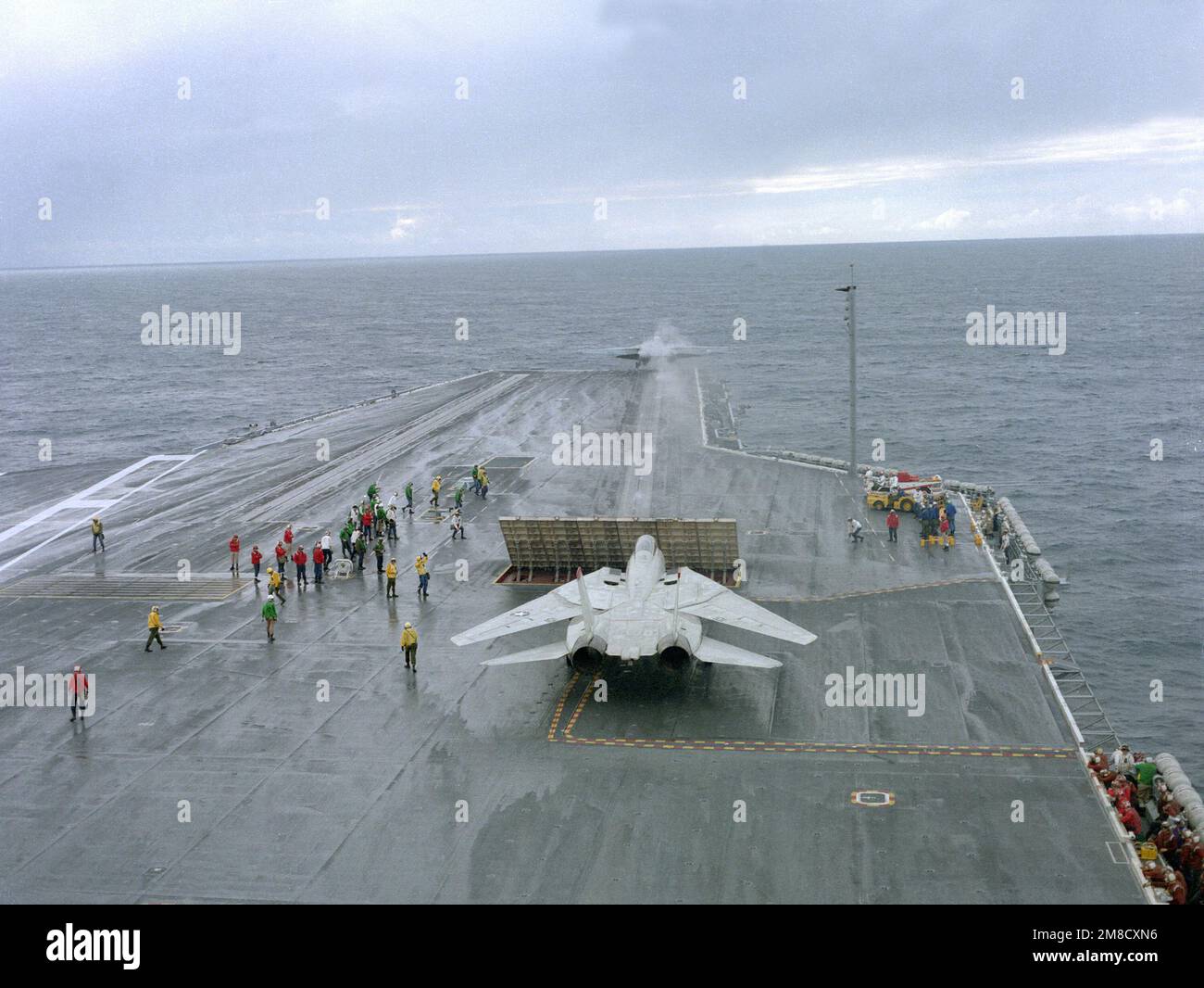 A Fighter Squadron 41 (VF-41) F-14A Tomcat aircraft waits behind the ...