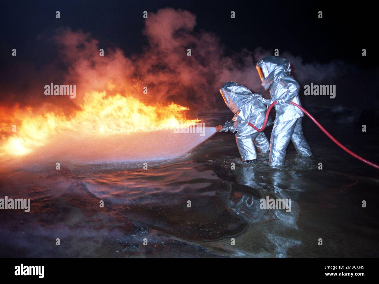 Dressed in proximity suits, two Marines of the air station's crash and ...