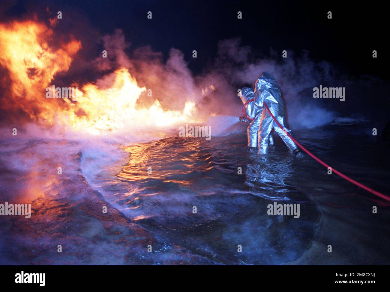 Dressed in proximity suits, two Marines of the air station's crash and ...