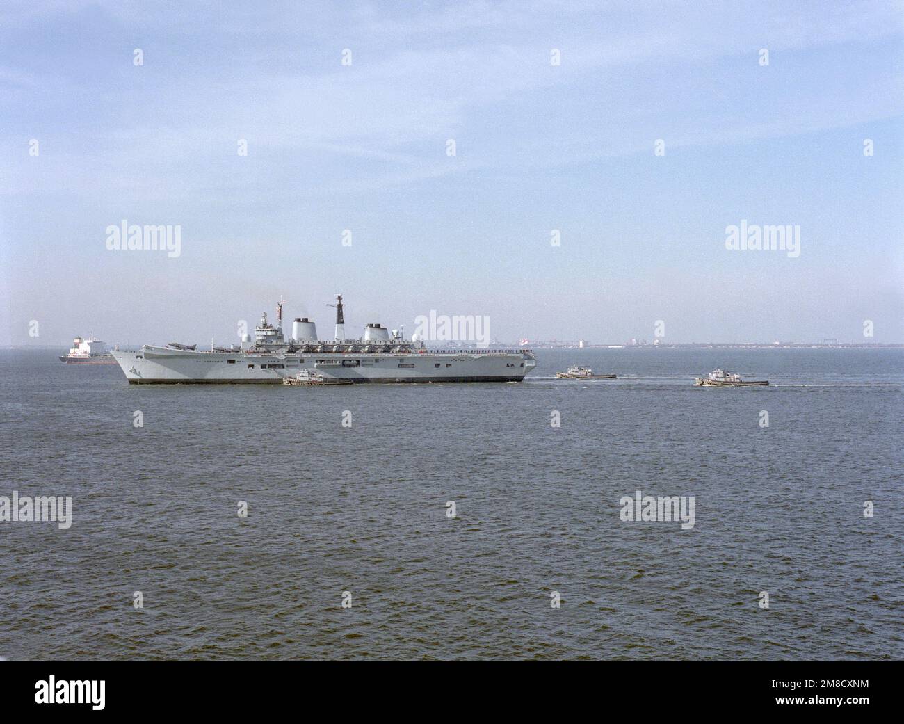 Escorted by U.S. Navy large harbor tugs, the British light aircraft ...