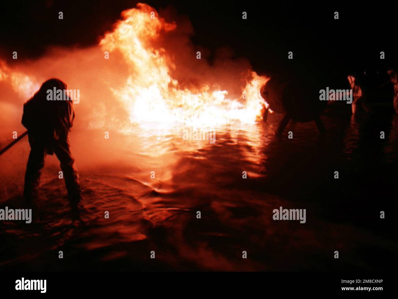 Dressed in proximity suits, two Marines of the air station's crash and ...