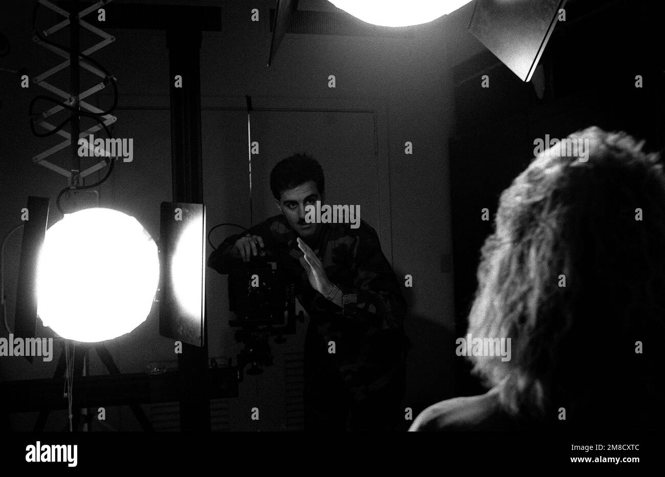 SGT Rick Staley prepares to take a portrait at the base photo lab. Base ...