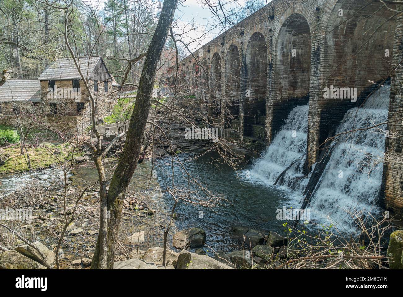 On the other side of the stone bridge with water flowing downward that ...