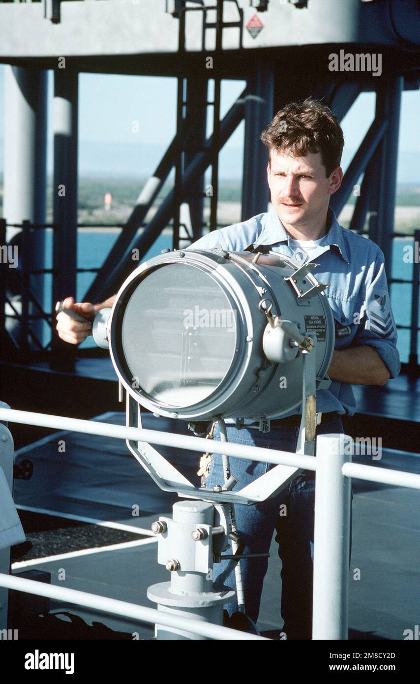 A signalman works the signalling lever on a searchlight mounted on the ...