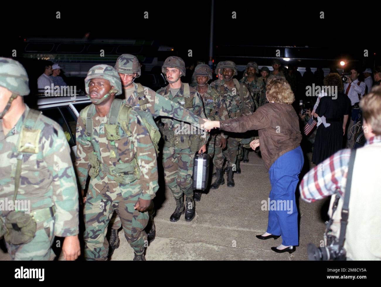Sergeant James Jones of the 6th Infantry Regiment grabs the hand of his ...